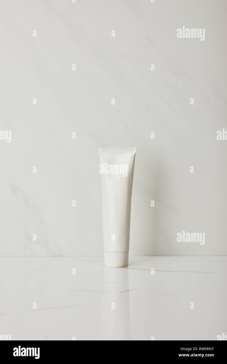 toothpaste in tube on white marble background Stock Photo - Alamy