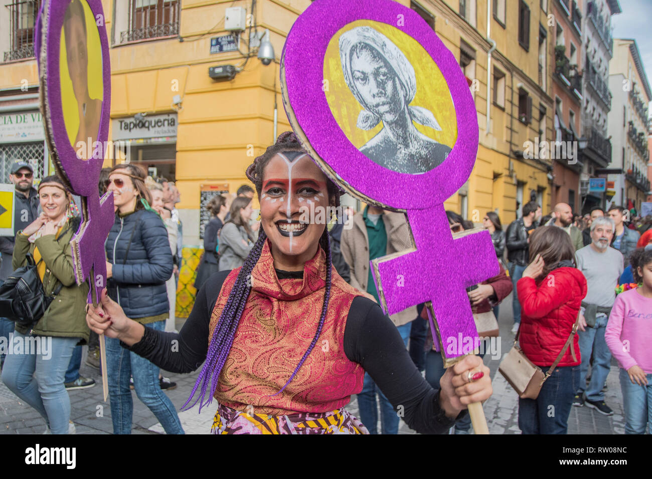 A woman seen with feminism and civil rights of Black women signs during ...