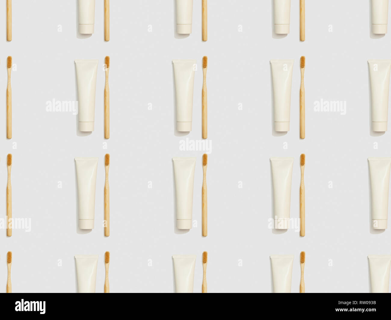 bamboo toothbrushes and toothpaste in tubes on grey background ...