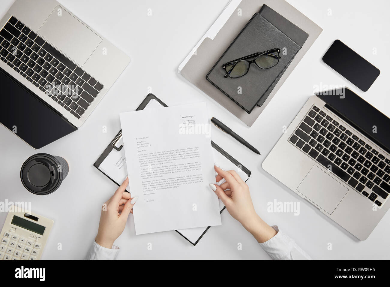 partial view of office worker holding contract at workplace Stock Photo ...