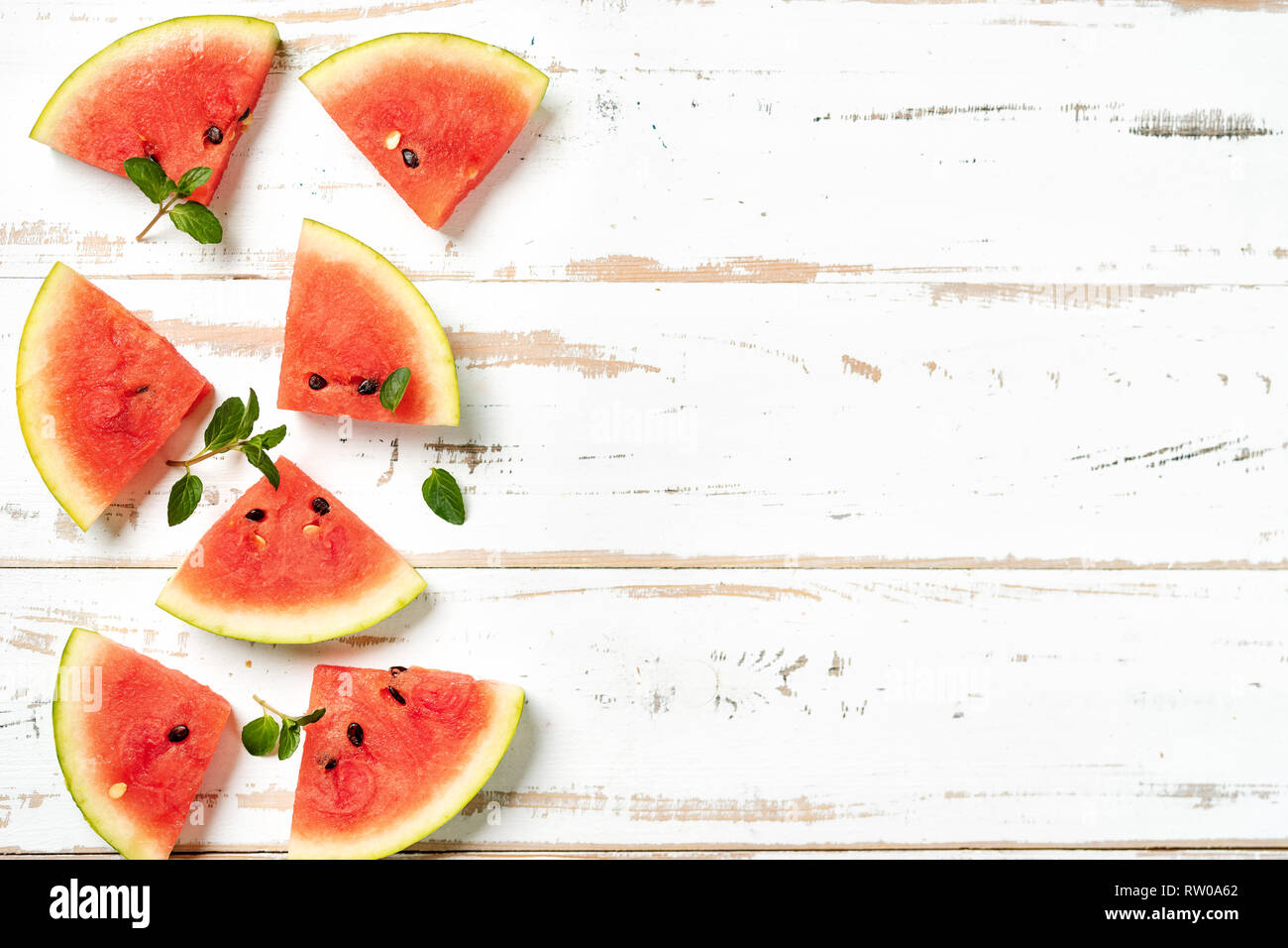 Top view of watermelon slices on white wooden background. Copy space ...