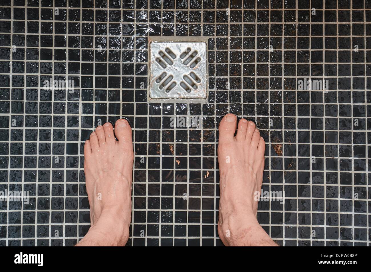 Shower water flowing on feet Stock Photo - Alamy
