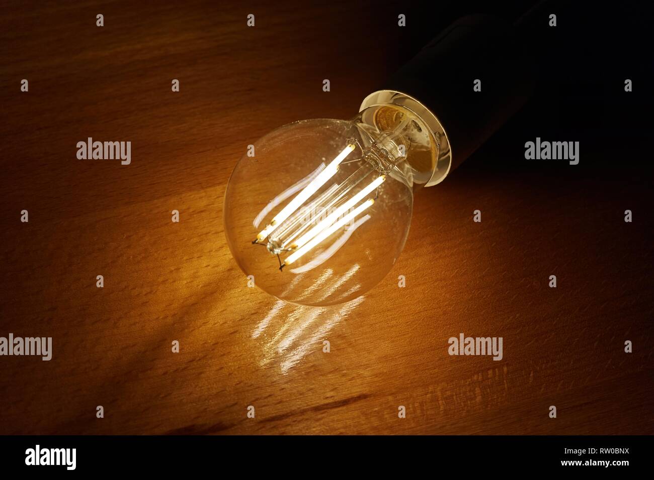 Light bulb on a table Stock Photo - Alamy