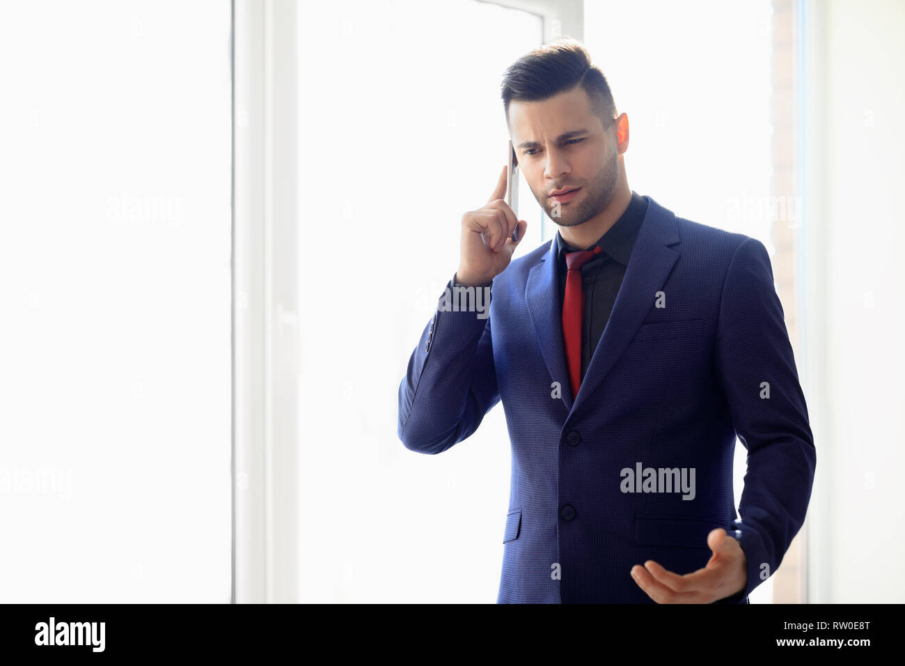 serious businessman talking on telephone in office Stock Photo - Alamy