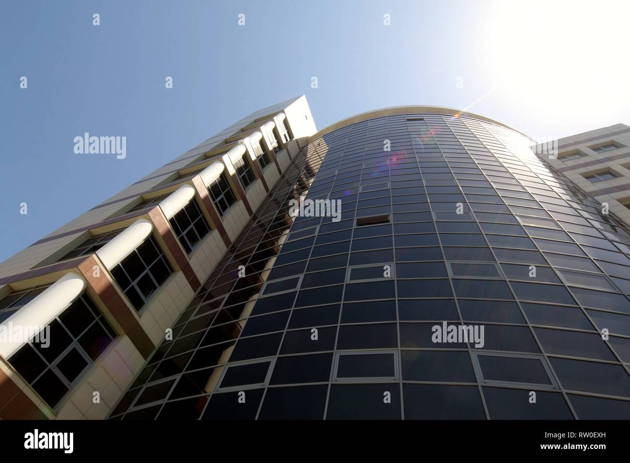 commercial high-rise building in the sun highlights in the city center ...