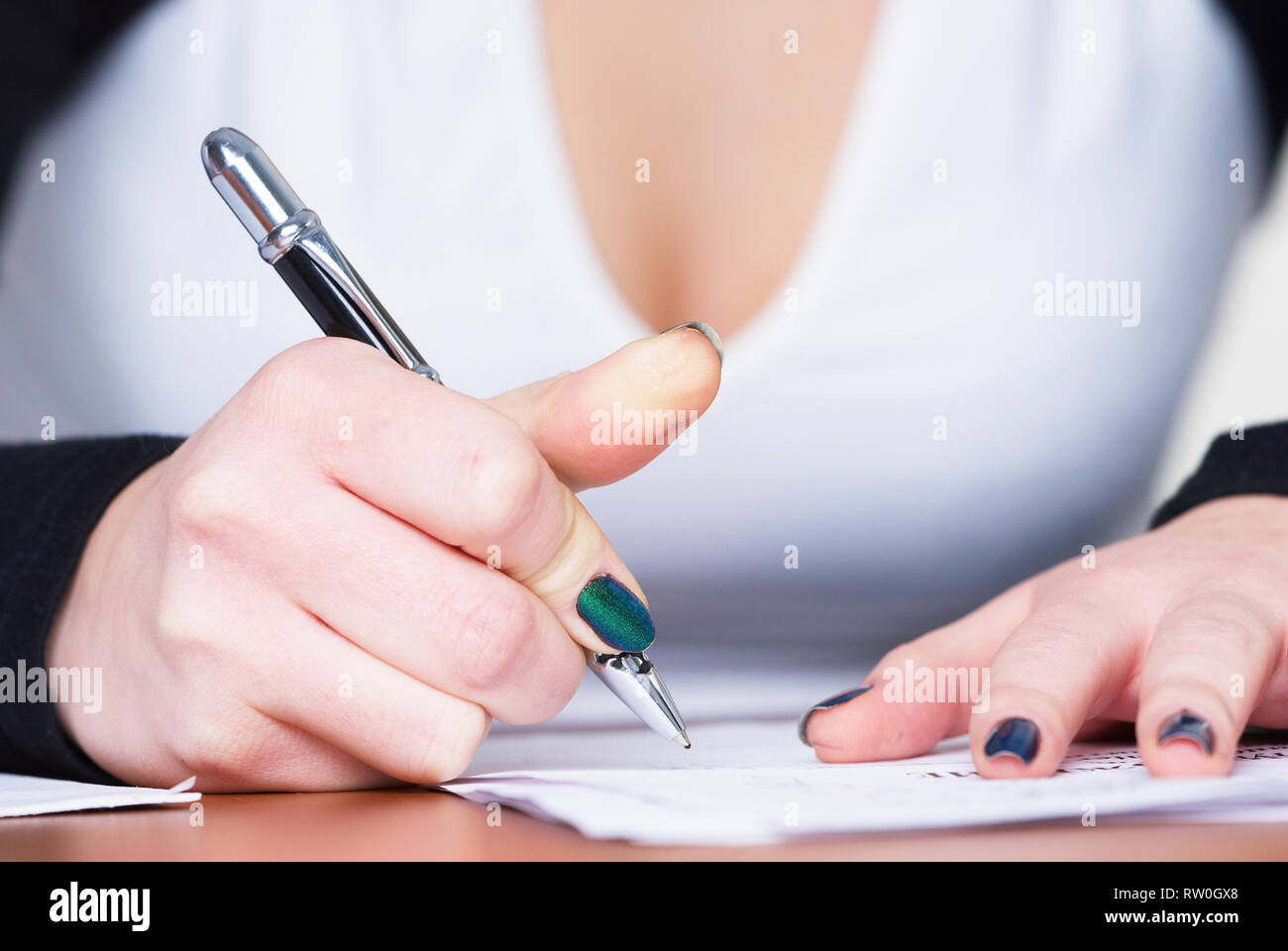 person's female hand signing an important document Stock Photo - Alamy