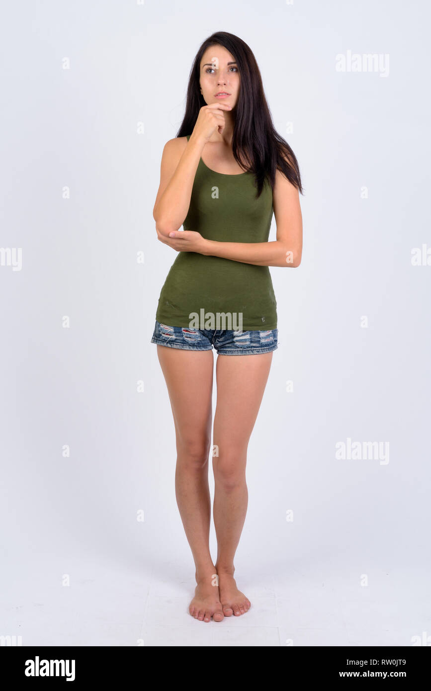 Full body shot of young beautiful woman thinking Stock Photo - Alamy