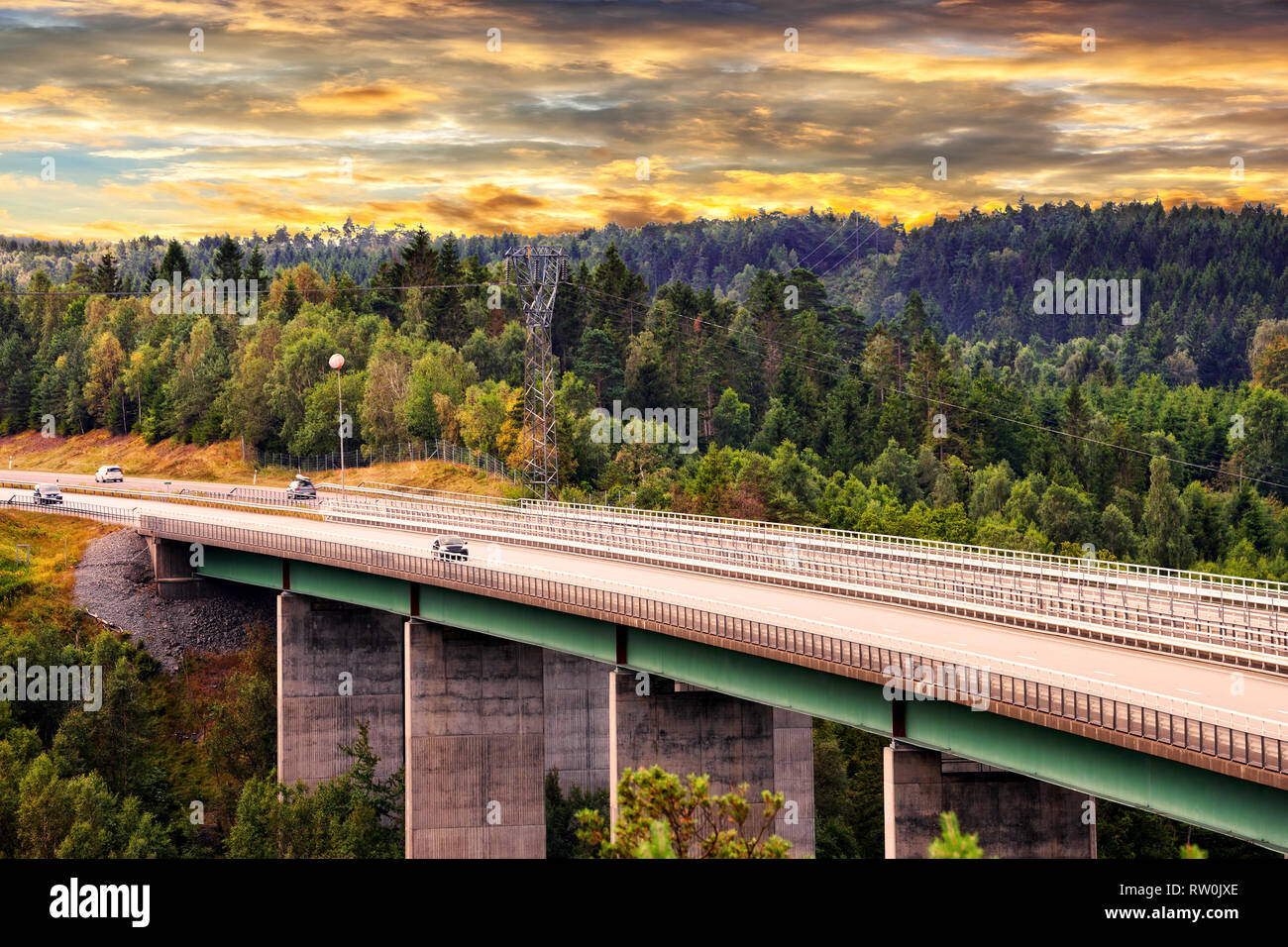 Road with a concrete bridge through forest areas Stock Photo - Alamy