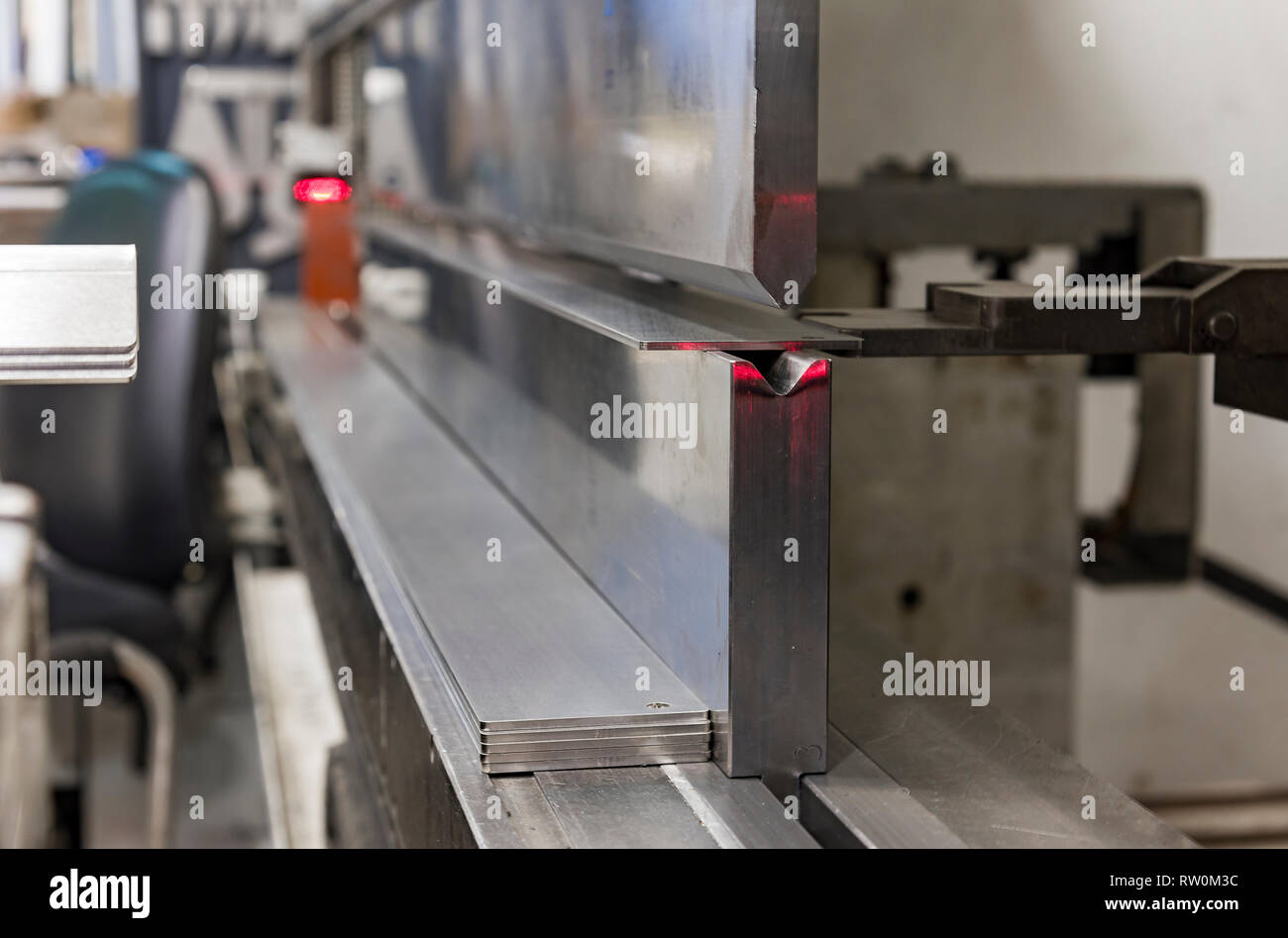 operator bending metal sheet by sheet bending machine bending of metal ...