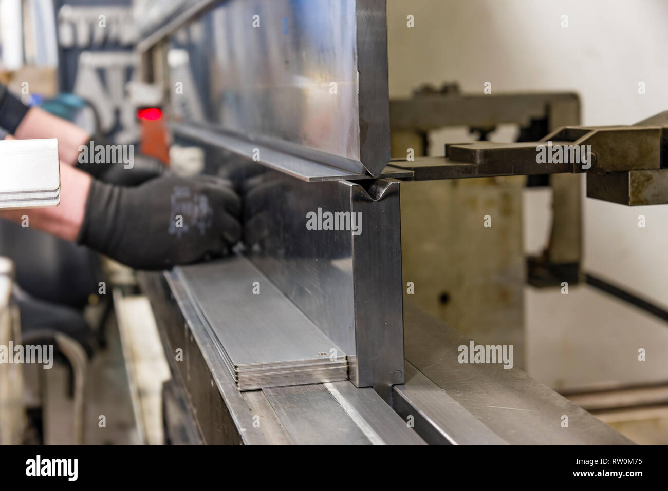 operator bending metal sheet by sheet bending machine bending of metal ...