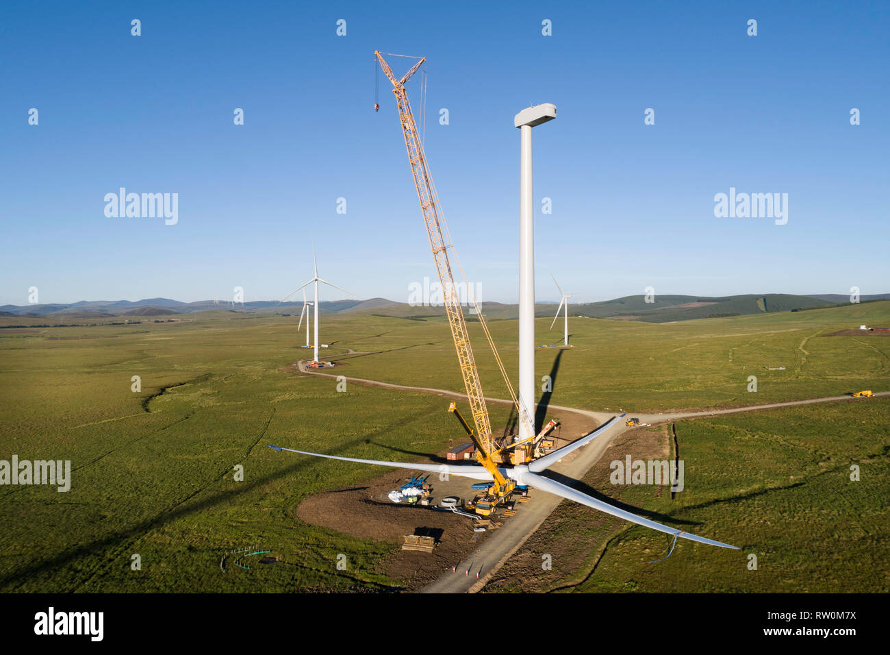 Aerial image showing construction of wind turbines using cranes at ...