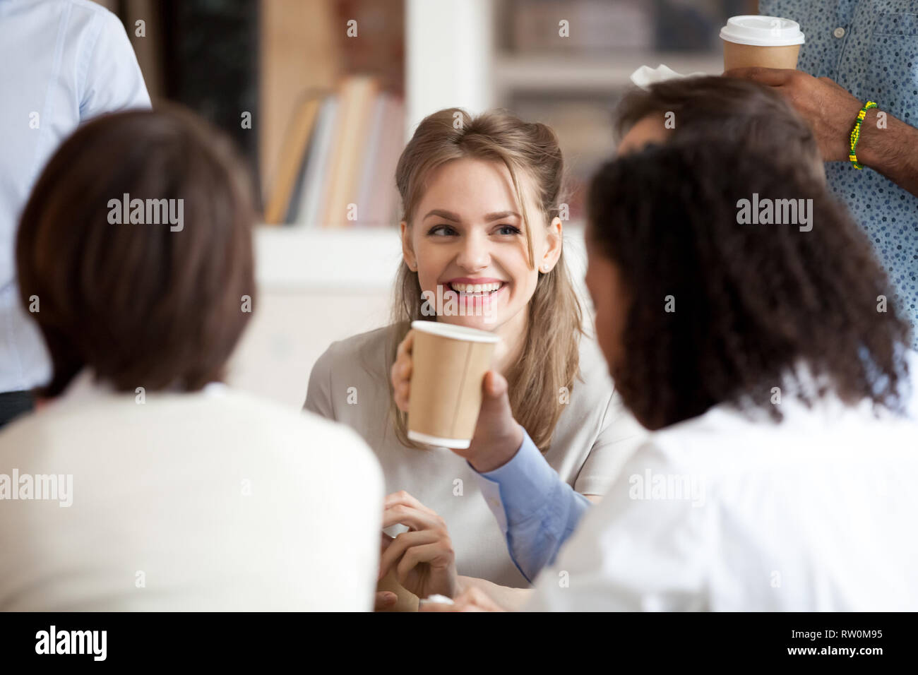 Colleagues take a break during working day talking drinking coffee ...