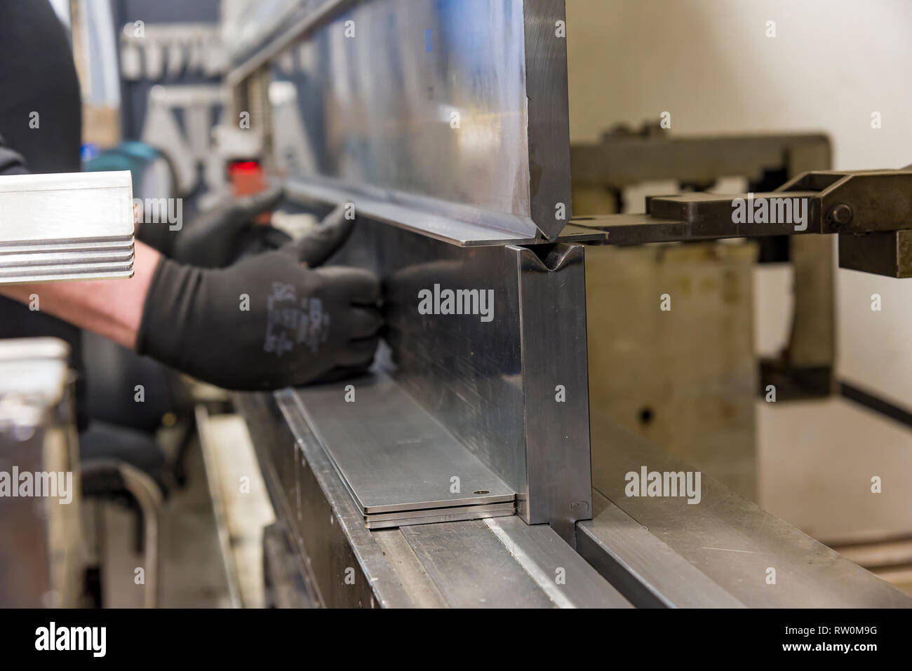 operator bending metal sheet by sheet bending machine bending of metal ...