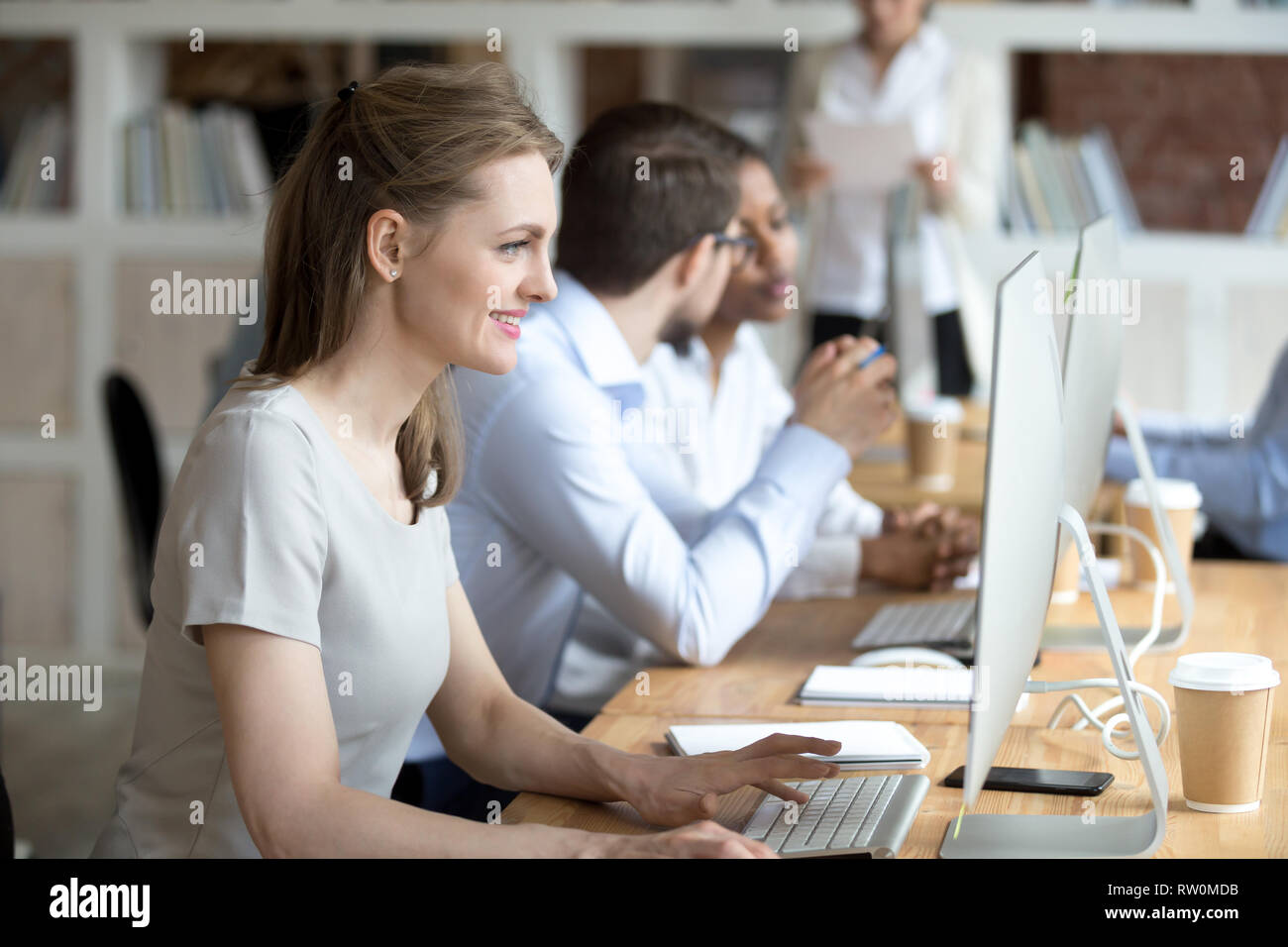 Successful manager working on pc reading positive message Stock Photo ...