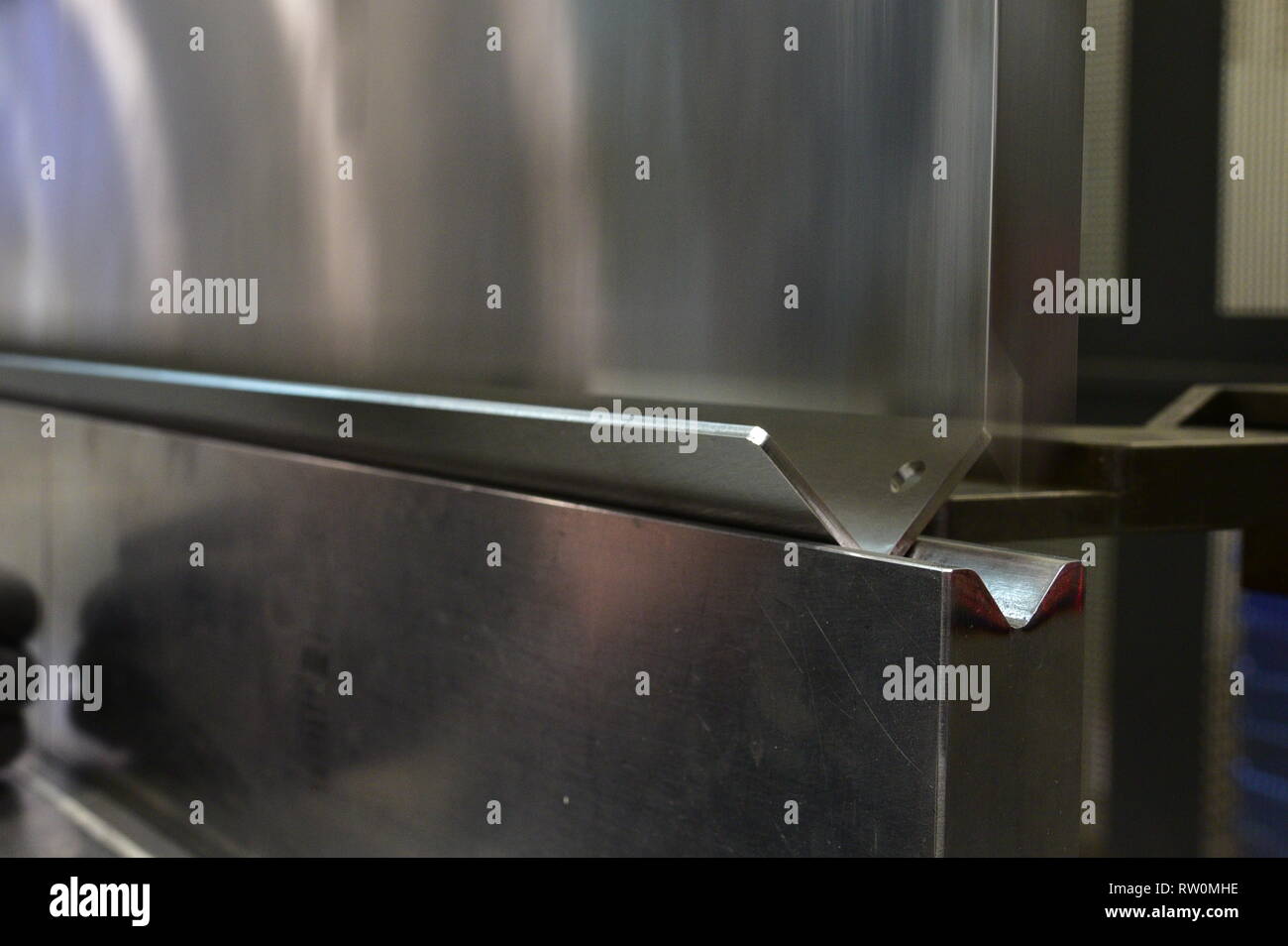 operator bending metal sheet by sheet bending machine bending of metal ...