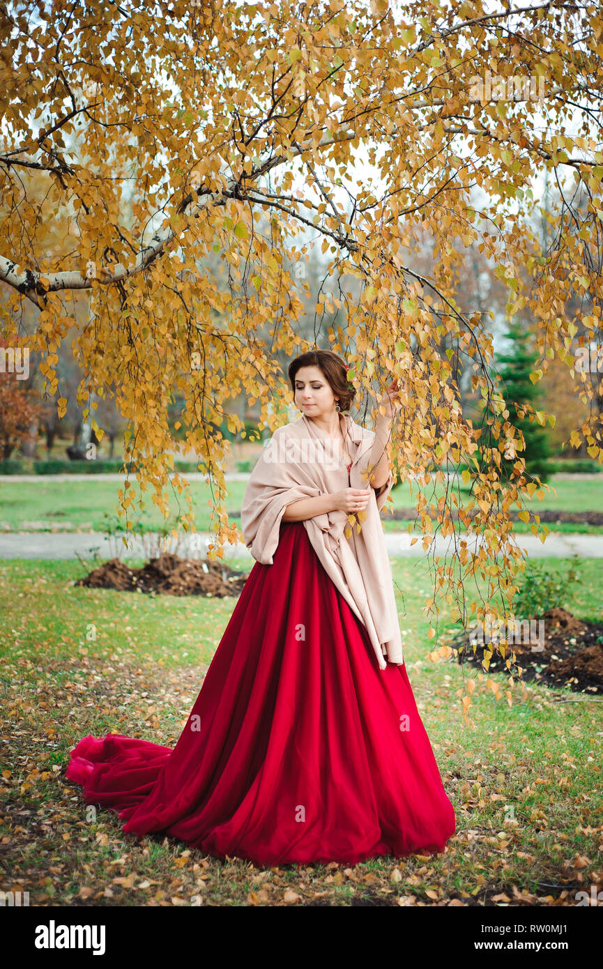 beautiful girl in a red dress in the autumn forest Stock Photo - Alamy