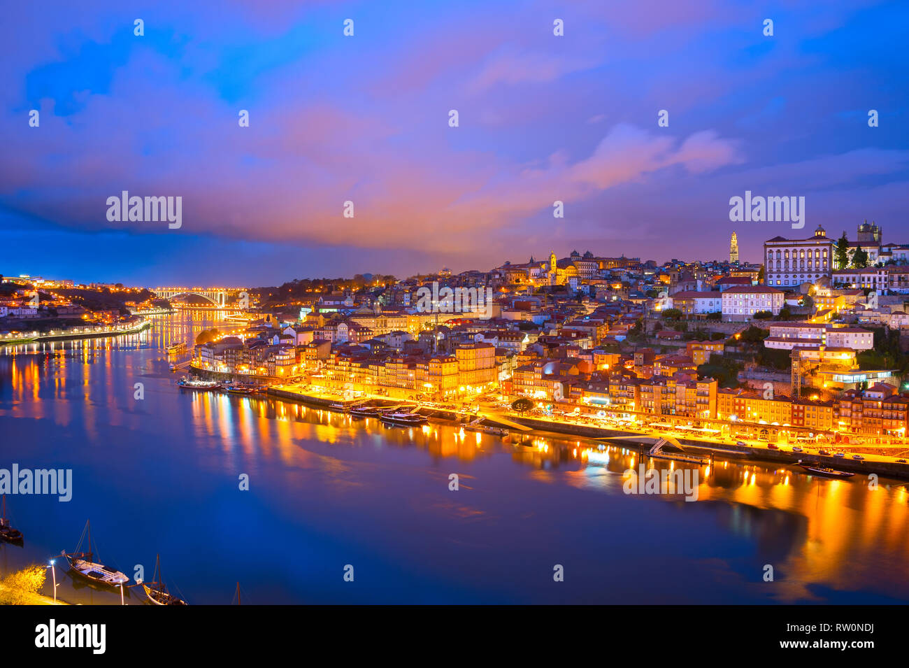 Colorful afterglow skyline of Porto illuminated old town with clouds ...