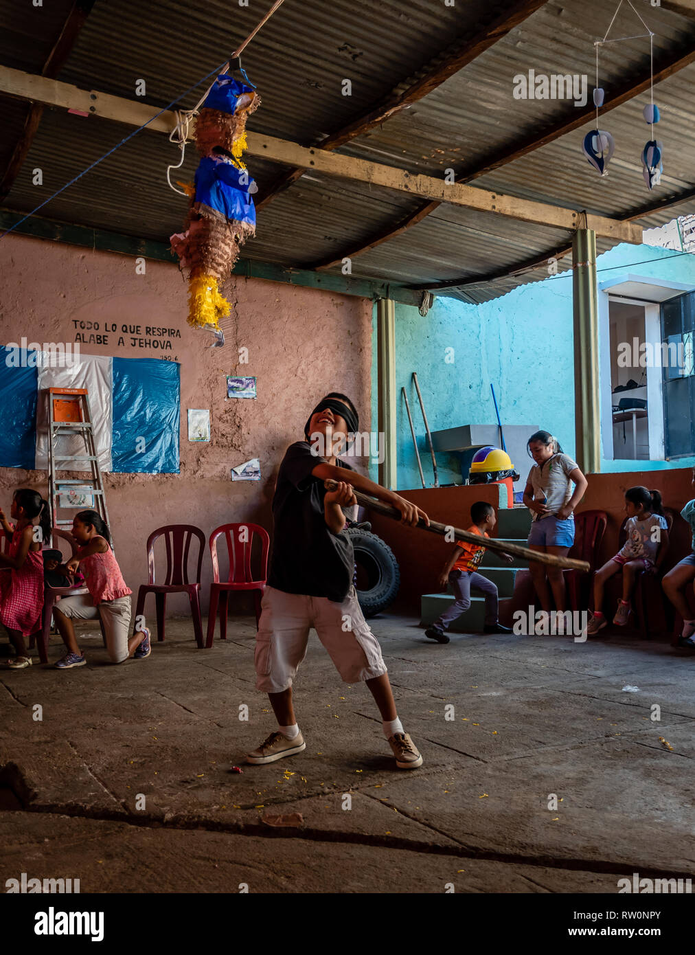 young latin boy swinging at pinata at Guatemalan birthday party Stock ...