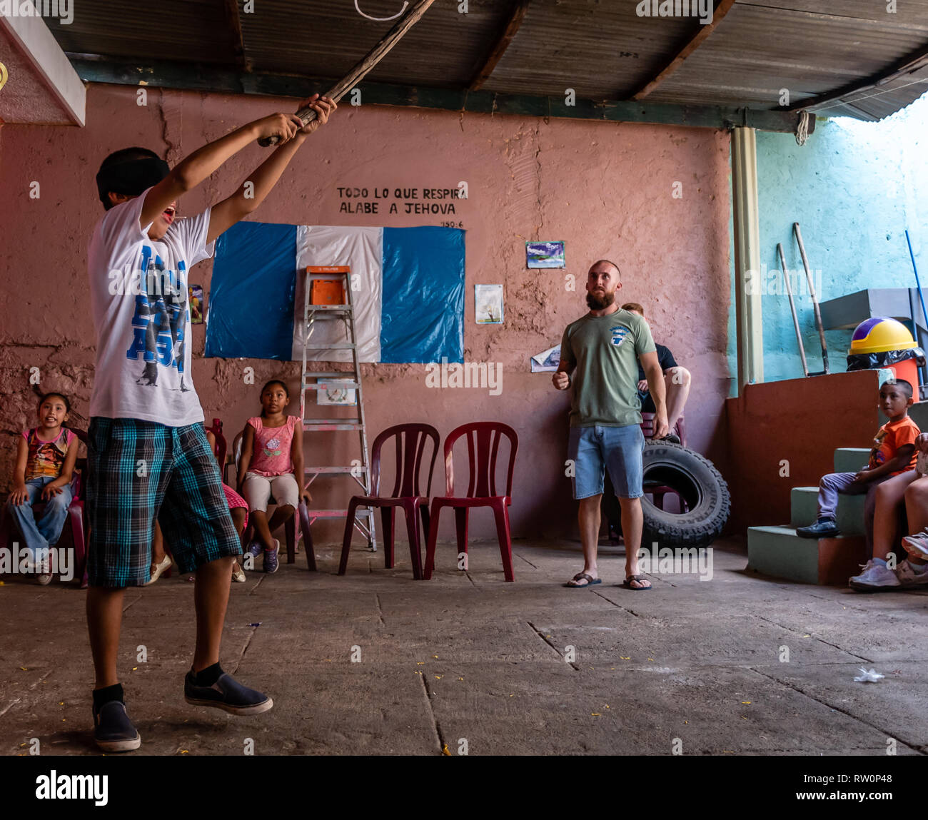 young latin boy swinging at pinata at Guatemalan birthday party Stock ...
