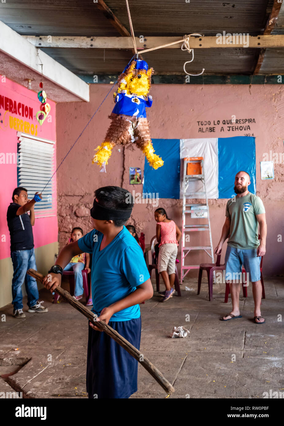 Girl swinging at pinata hi-res stock photography and images - Alamy