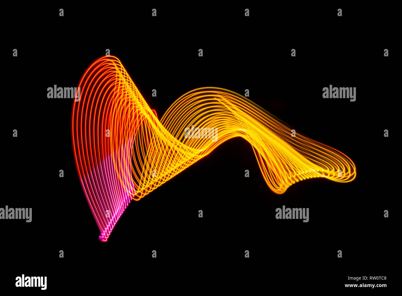 Abstract orange and yellow neon glowing crossing lines pattern. Dark ...