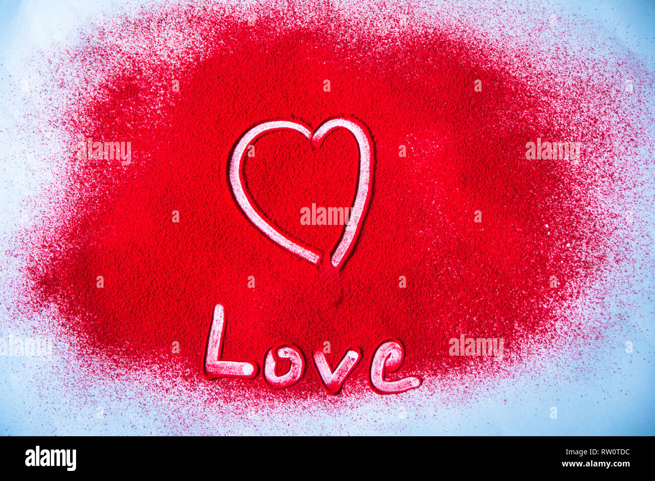 Red heart symbol and love on red powder Stock Photo - Alamy