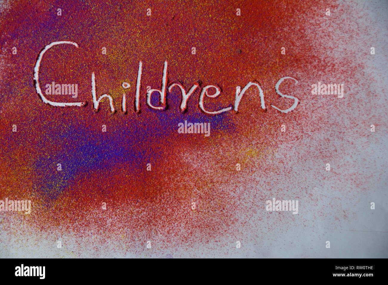 Children's word on colorful color powder Stock Photo - Alamy