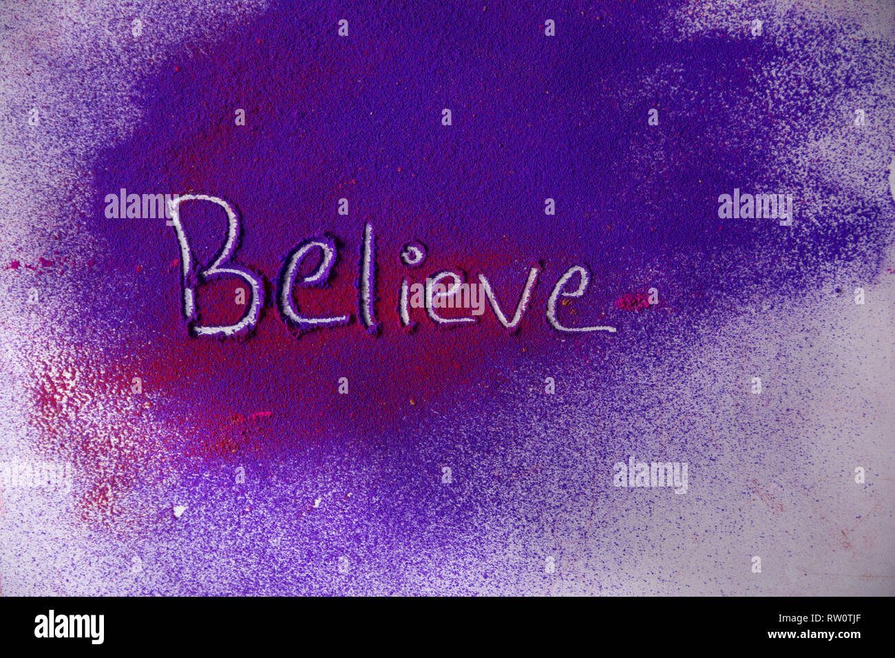 Colorful Powder written word Believe Stock Photo - Alamy