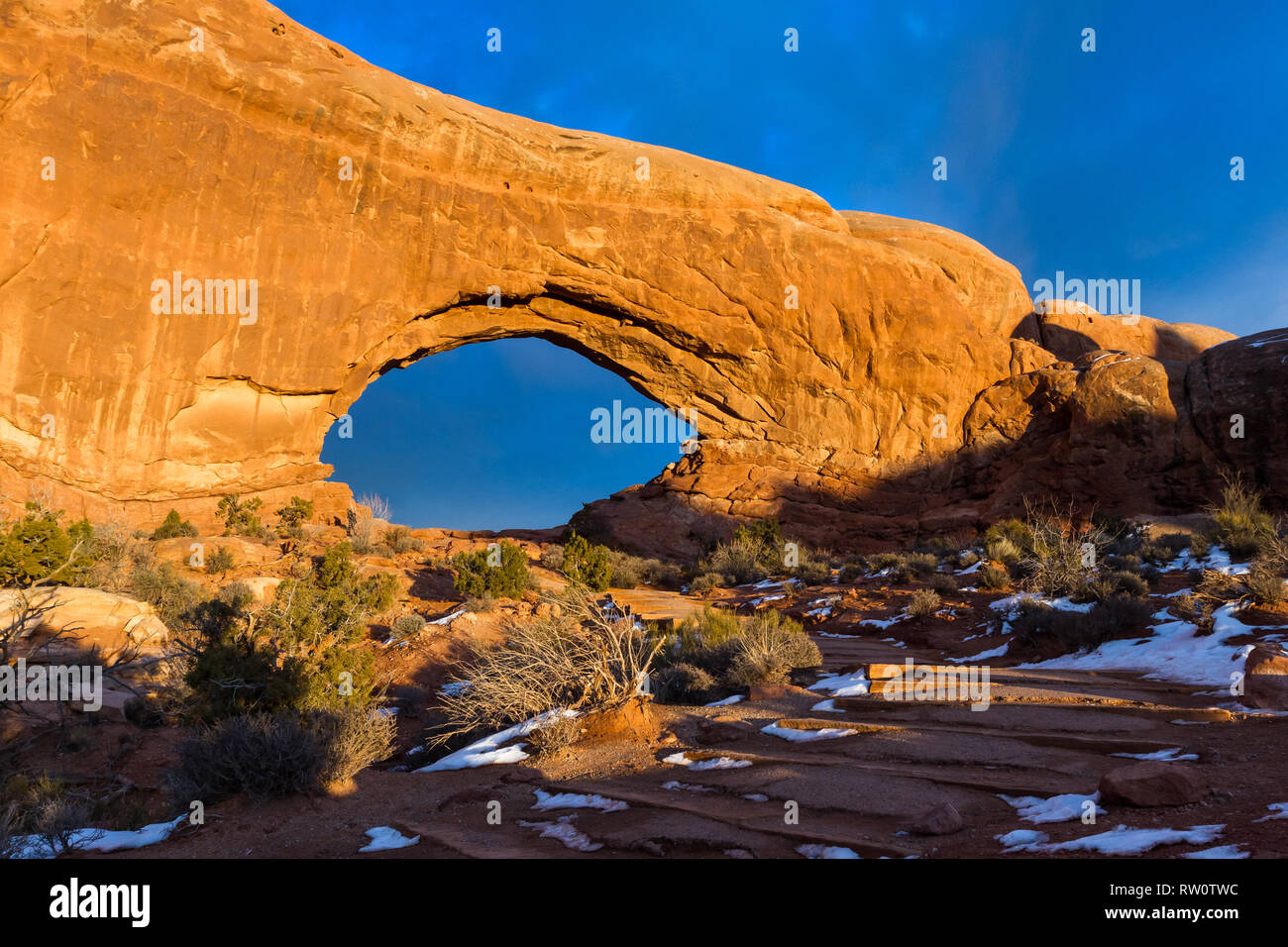 winter scene in Arches national park with a bit of snow on the ground ...
