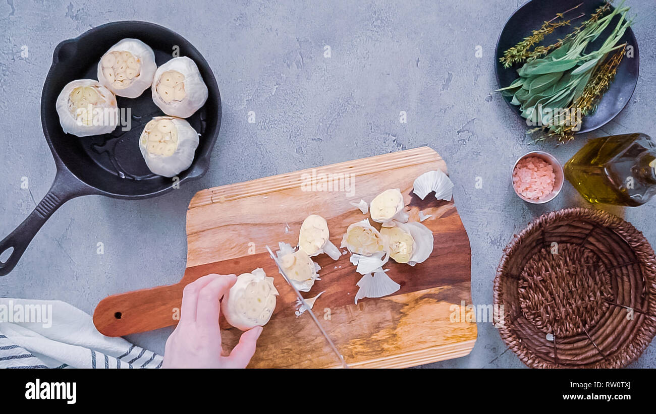 Flat lay. Preparing garlic spread by roasting garlic with fresh spices ...