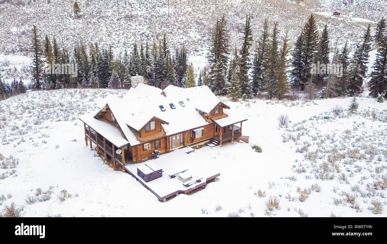 Aerial view of the mountain house covered in snow in the Winter Stock ...