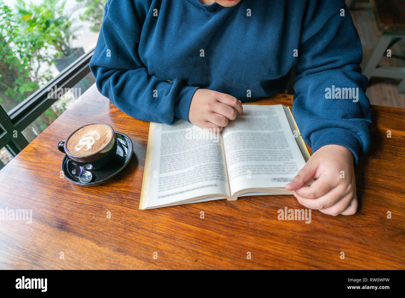 Top view of woman hand reading book Stock Photo - Alamy