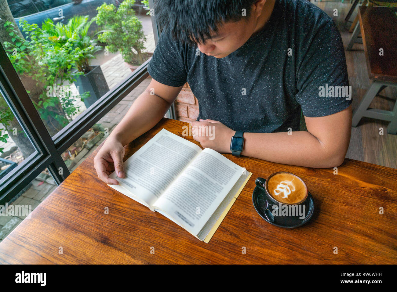 Top view of Asian man reading book Stock Photo - Alamy