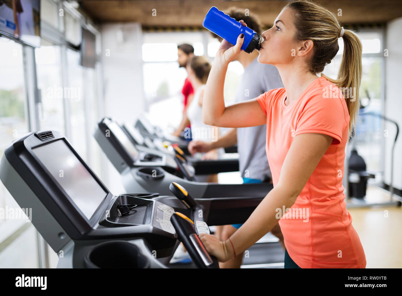 Picture of people running on treadmill in gym Stock Photo - Alamy