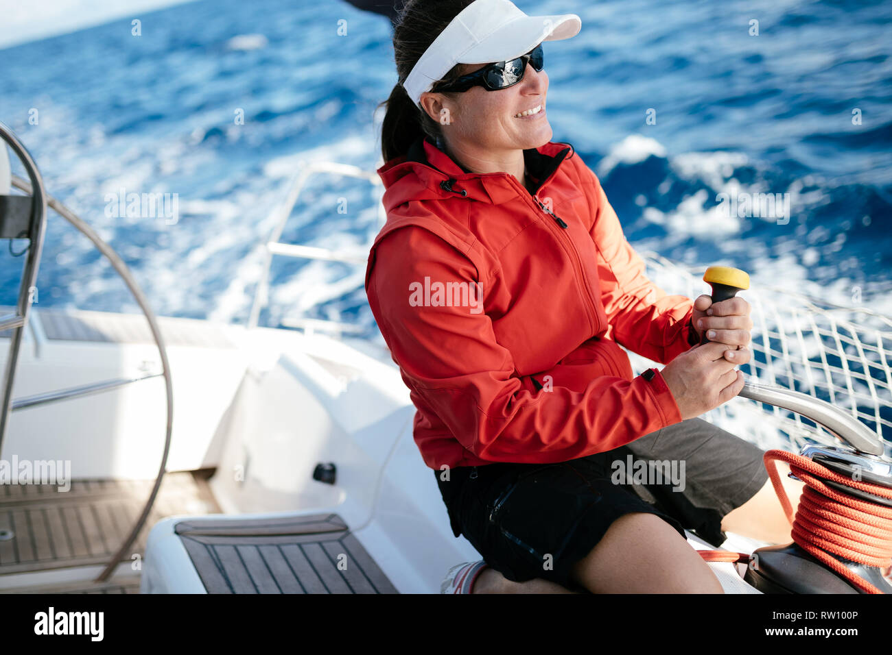 Attractive strong woman sailing with her boat Stock Photo - Alamy
