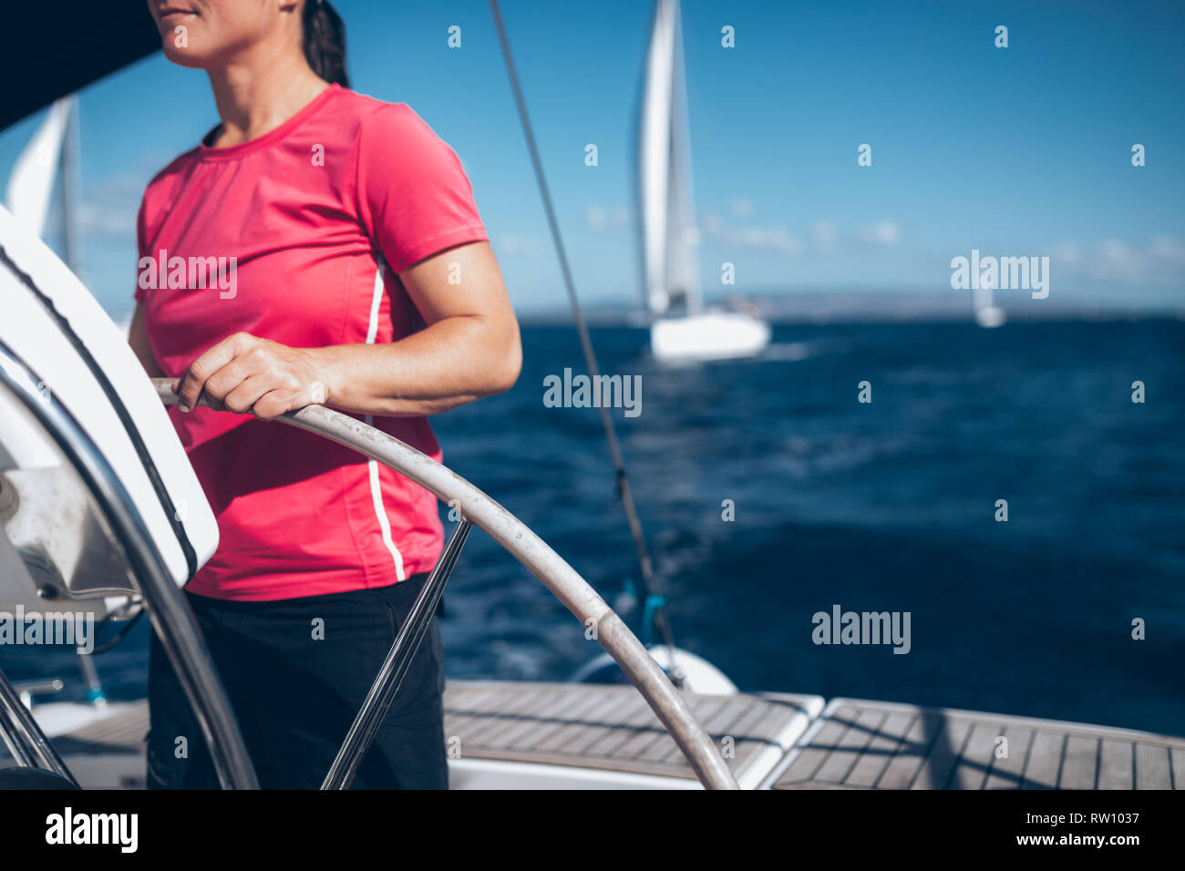 Happy strong woman sailing with her boat Stock Photo - Alamy