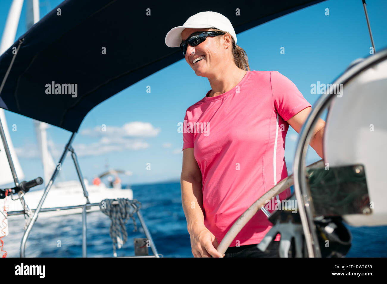 Happy strong woman sailing with her boat Stock Photo - Alamy