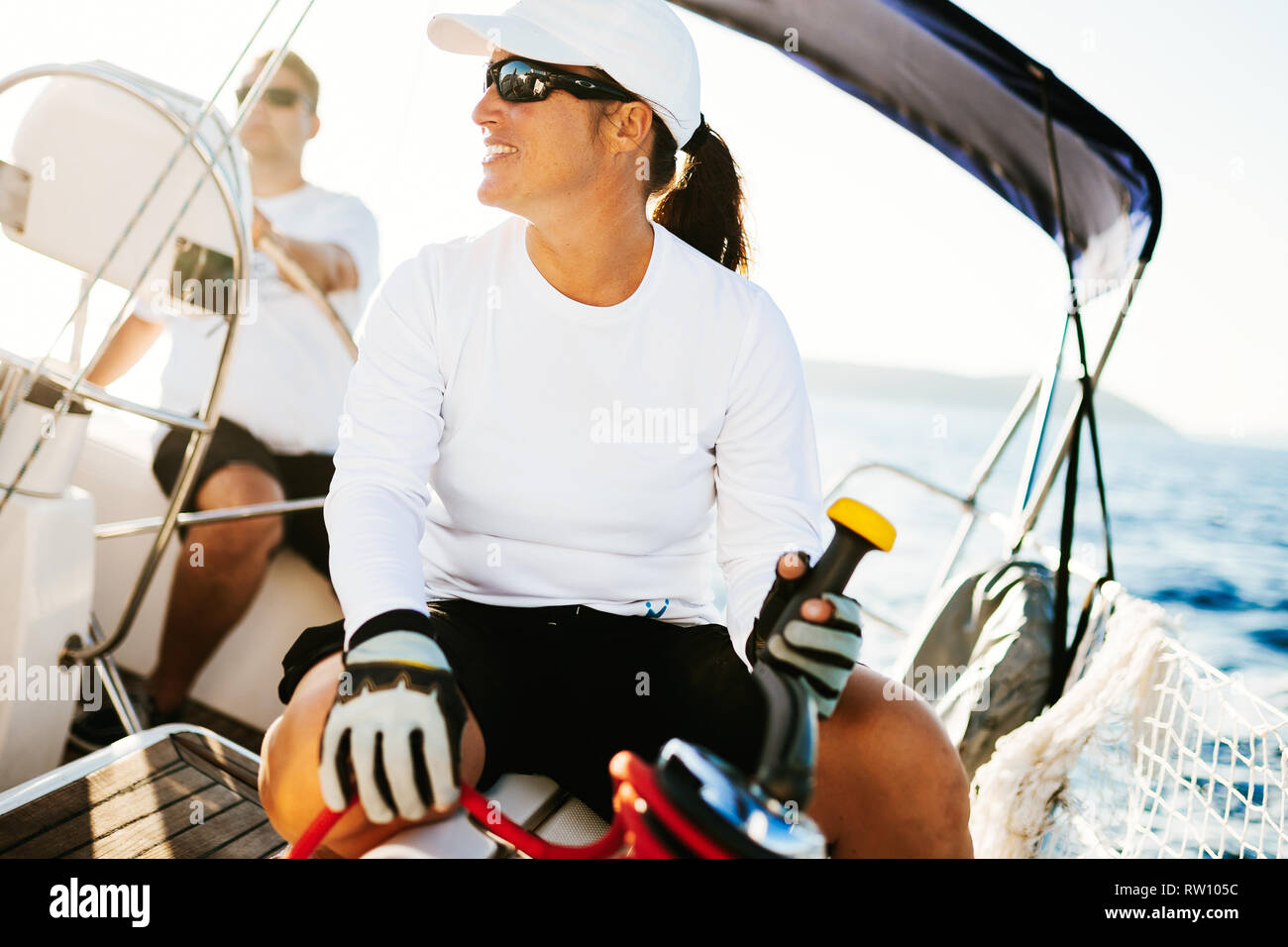 Attractive strong woman sailing with her boat Stock Photo - Alamy