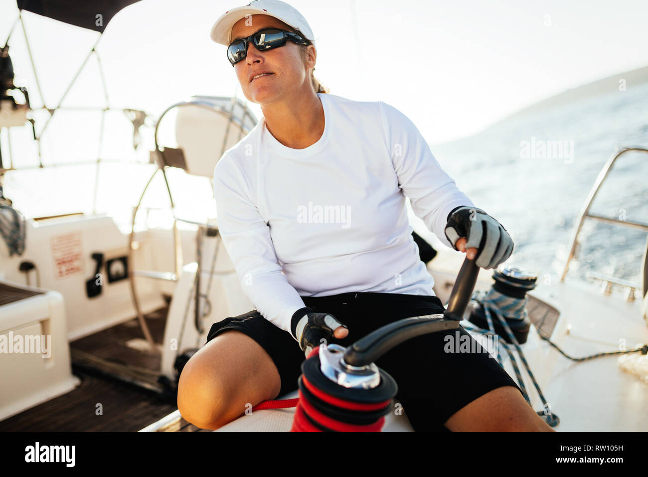 Attractive strong woman sailing with her boat Stock Photo - Alamy