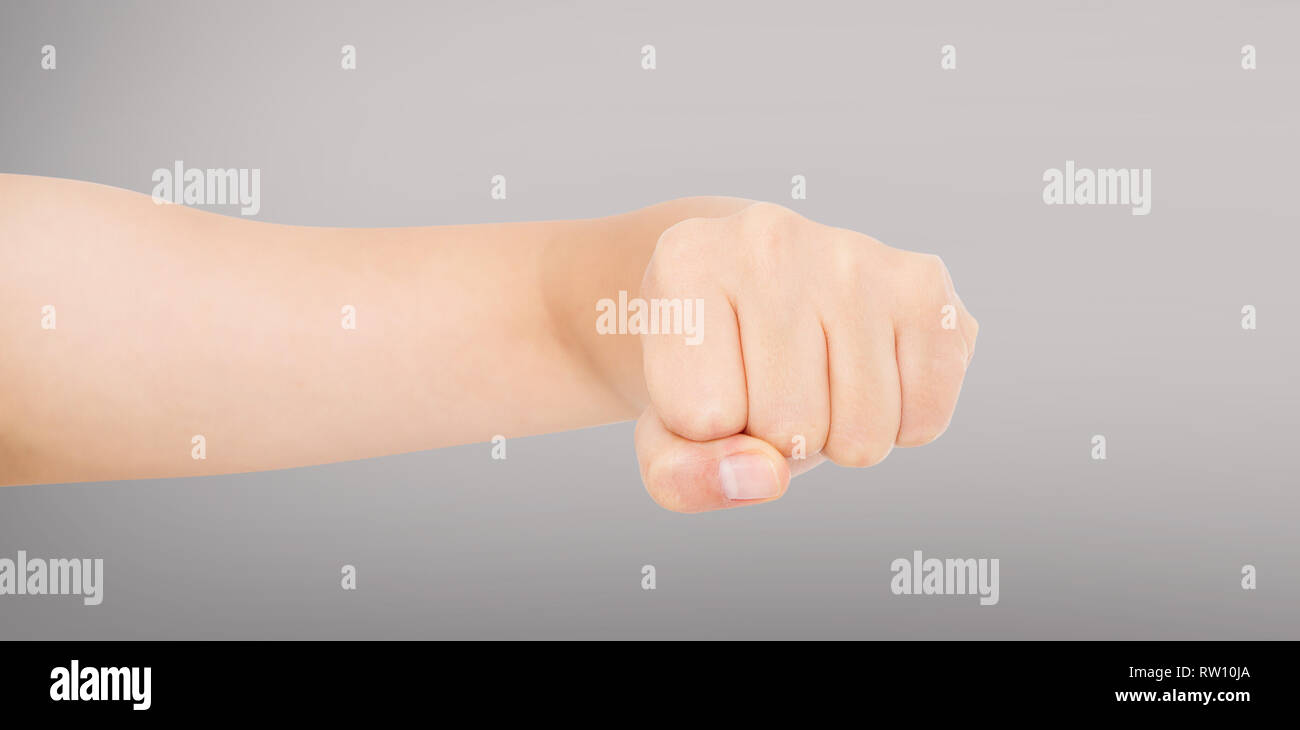 Woman fist isolated on a grey background. Front view Stock Photo - Alamy