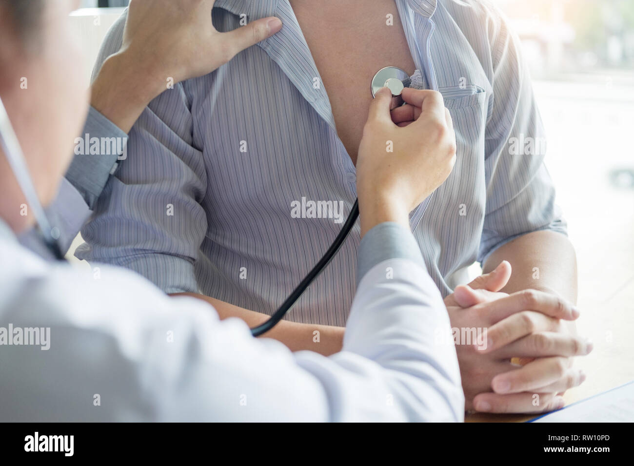 doctor is checking on patient's chest uses stethoscope to listen ...