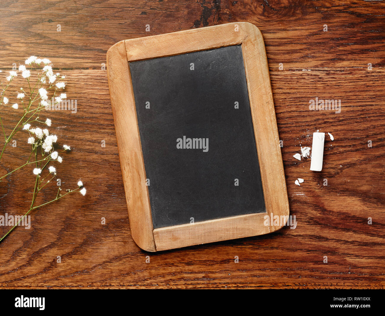 Chalk board and chalk on wooden table. Mockup for calligraphy and ...