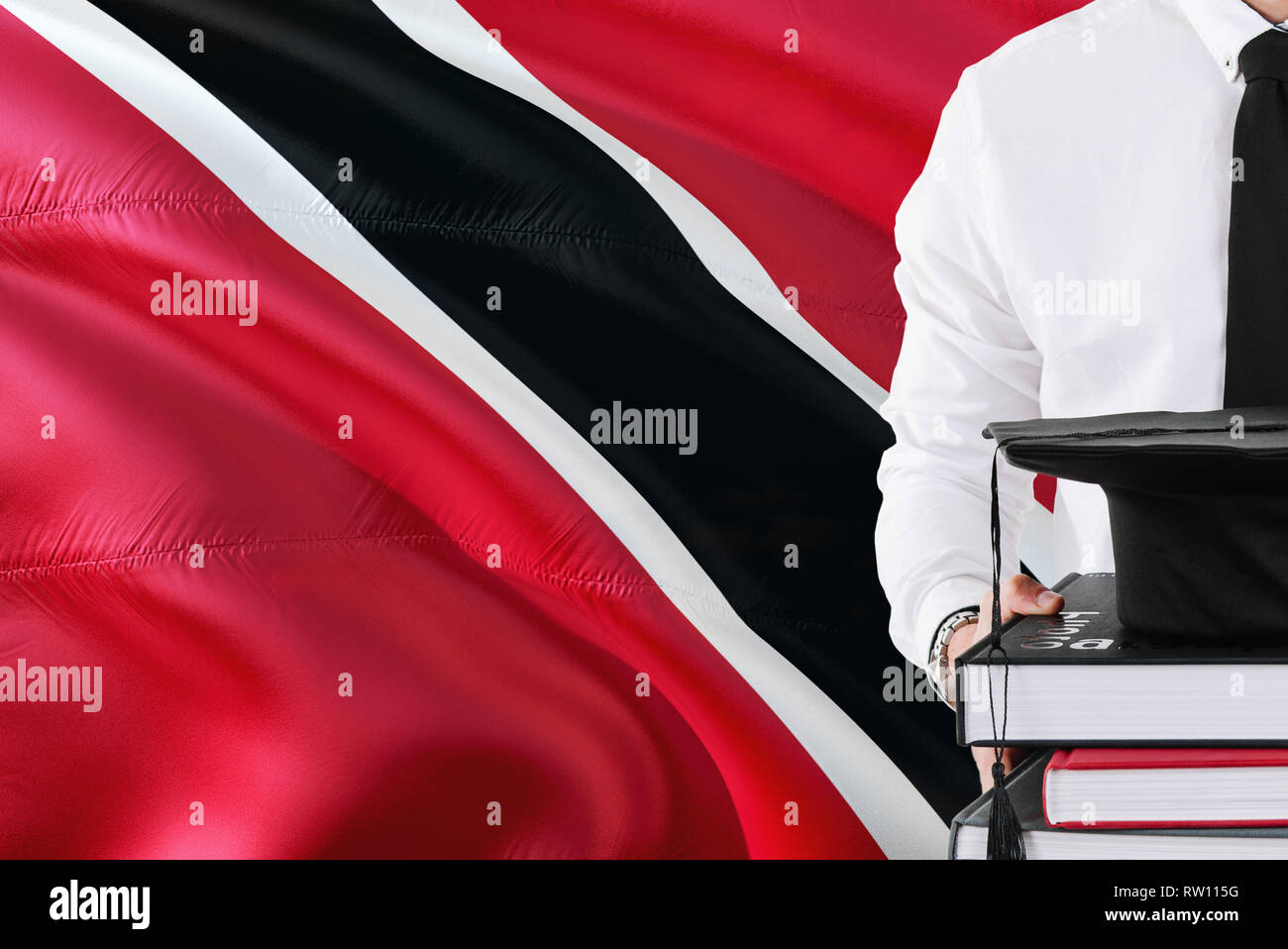 Successful student education concept. Holding books and graduation cap ...