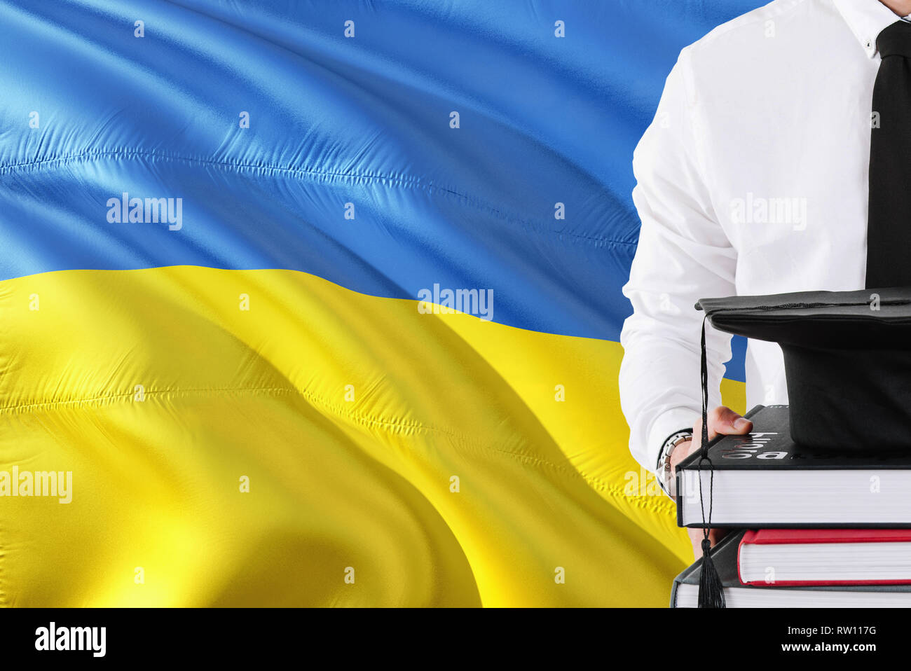 Successful Ukrainian student education concept. Holding books and ...