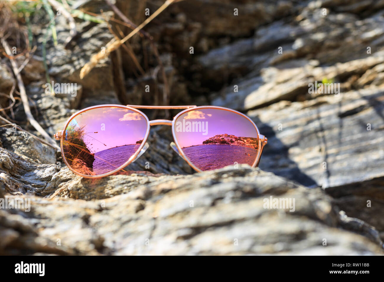 Sunglasses at the beach with sea reflection. Holidays, travel, vacation ...