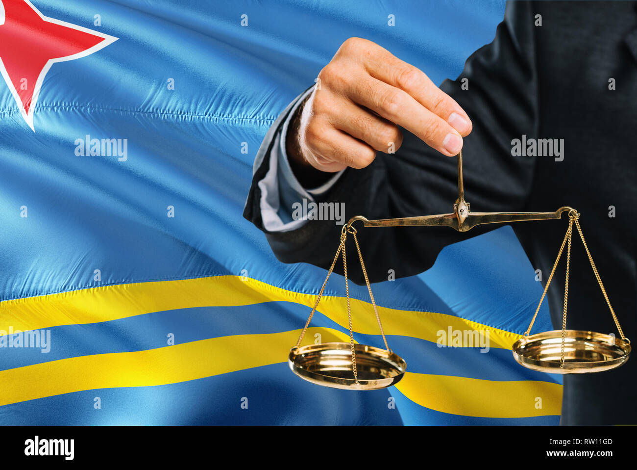 Judge Is Holding Golden Scales Of Justice With Aruba Waving Flag