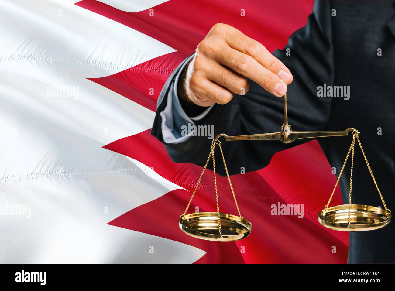 Bahraini Judge is holding golden scales of justice with Bahrain waving ...