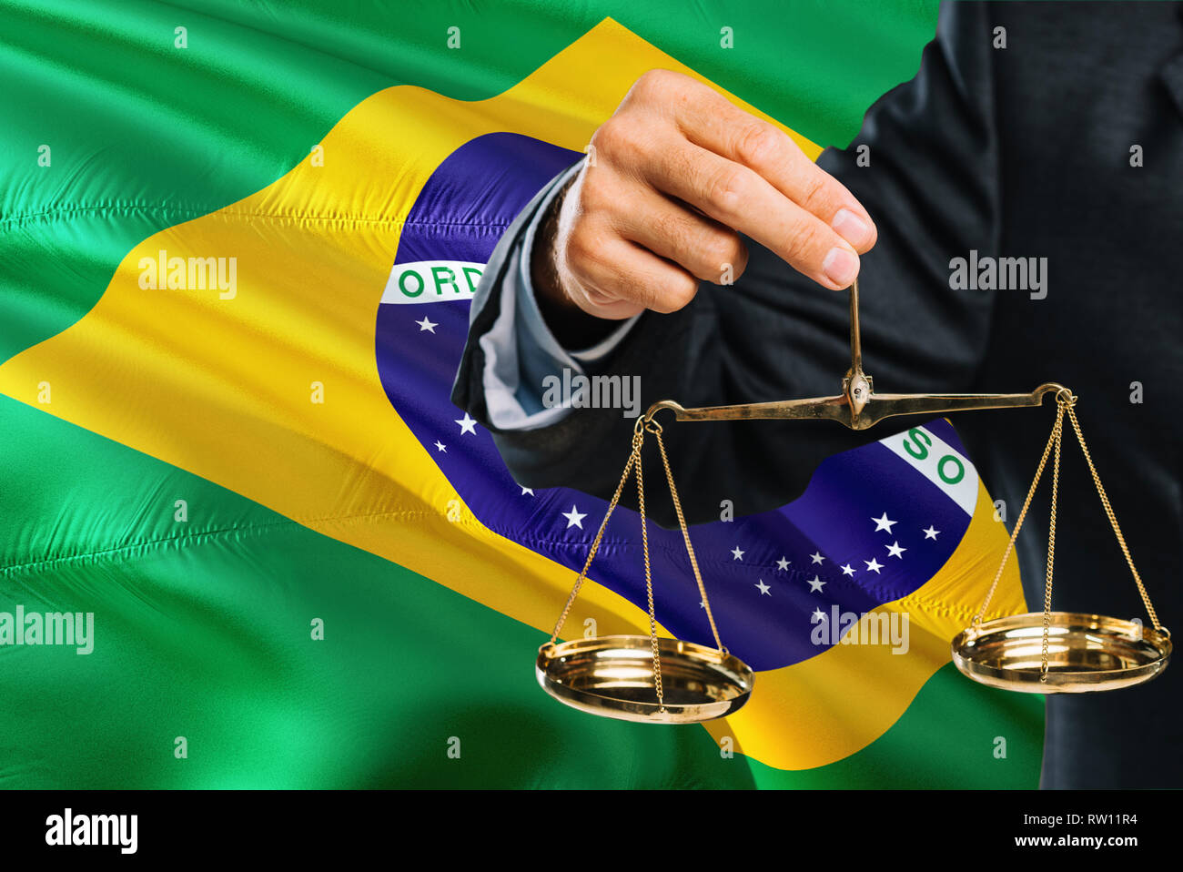 Brazilian Judge is holding golden scales of justice with Brazil waving ...