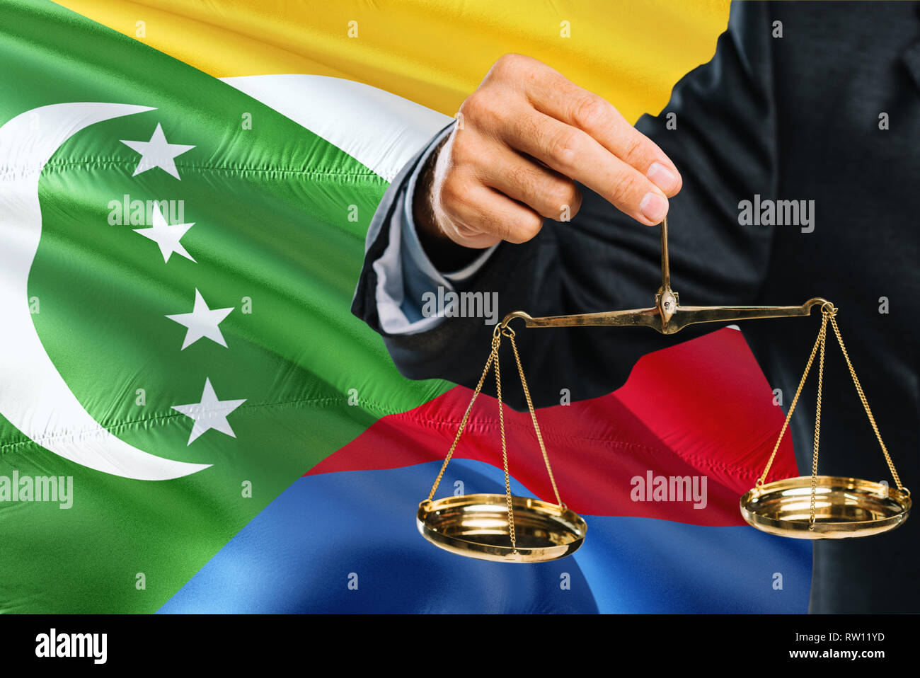 Comoran Judge is holding golden scales of justice with Comoros waving ...