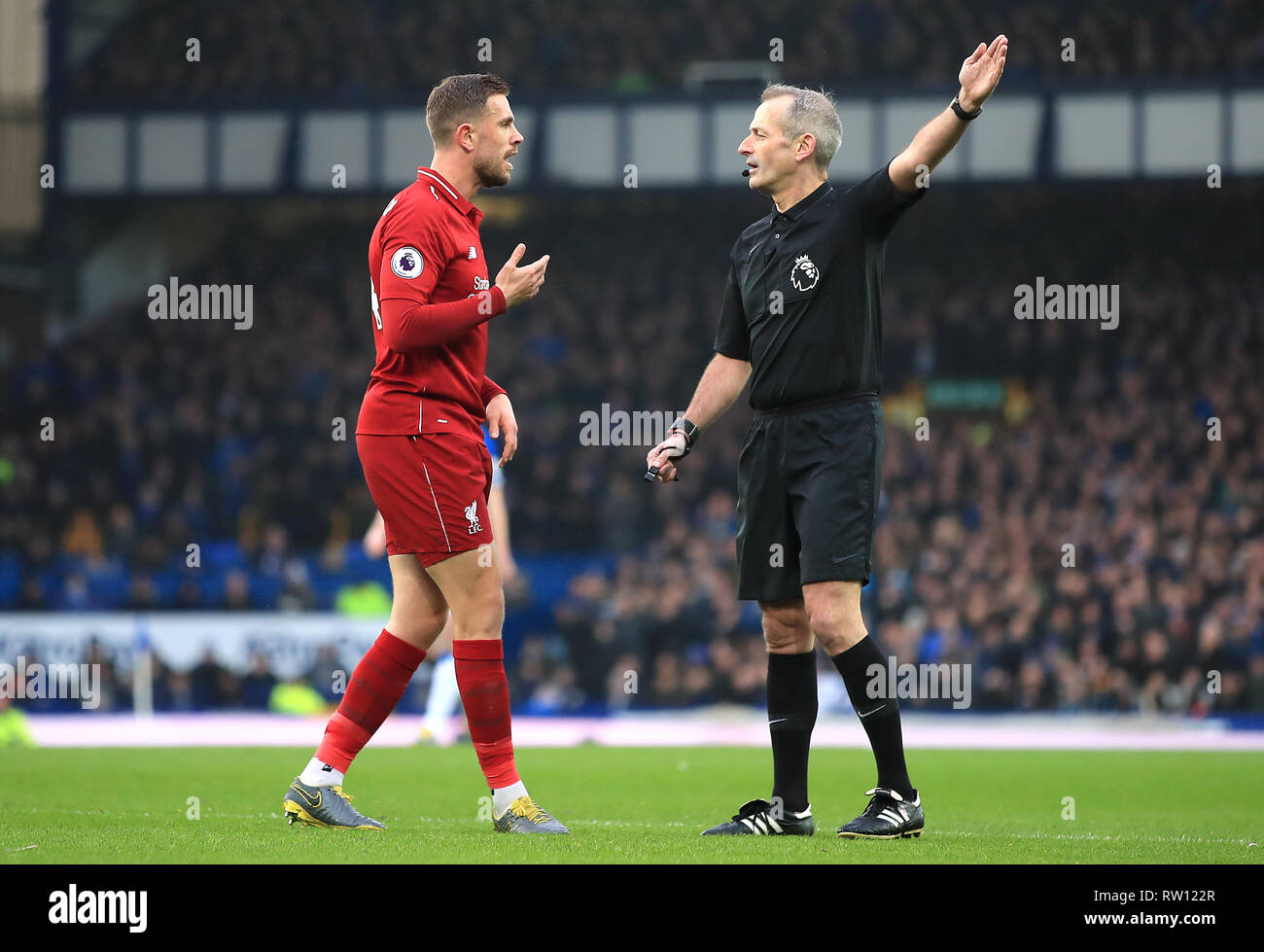 Liverpool's Jordan Henderson (left) in discussion with referee Martin ...